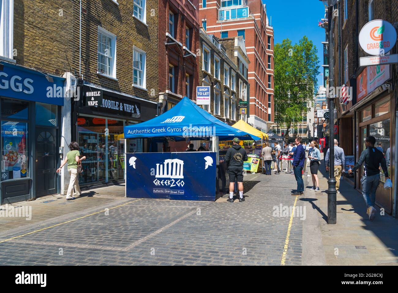 People out and about on a sunny day in Strutton Ground market. London ...