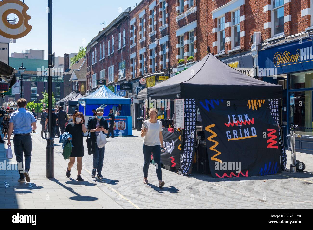 People out and about on a sunny day in Strutton Ground market. London ...