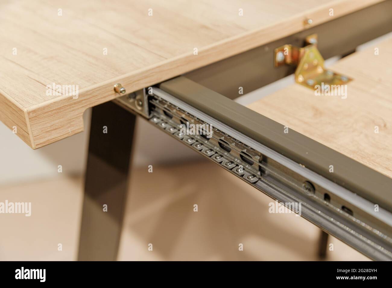 Extendable dinning table. Slide gear close up view Stock Photo - Alamy