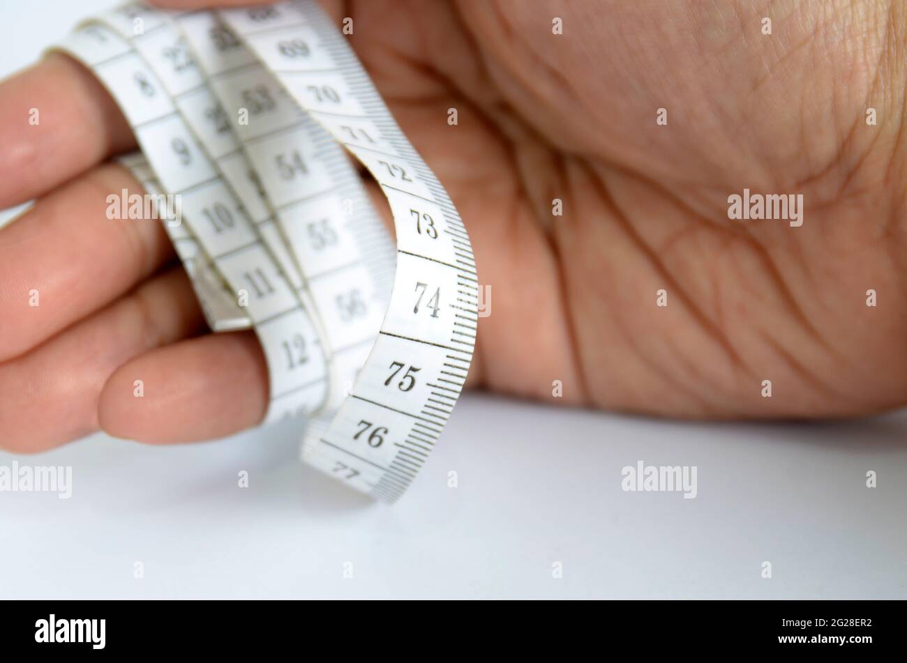 hand with tape measure, for measuring body.Conceptual images for ...