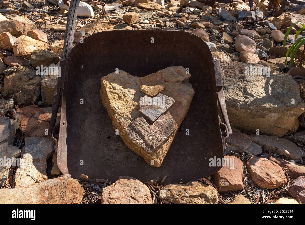 Heart-shaped rocks inside a large metal scoop on a farm near the top of ...
