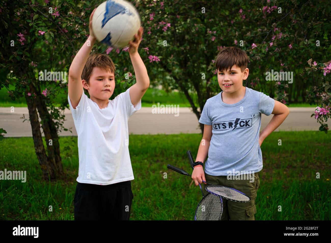 Two friends boys with tennis rackets and a ball, portrait of pre-teen ...
