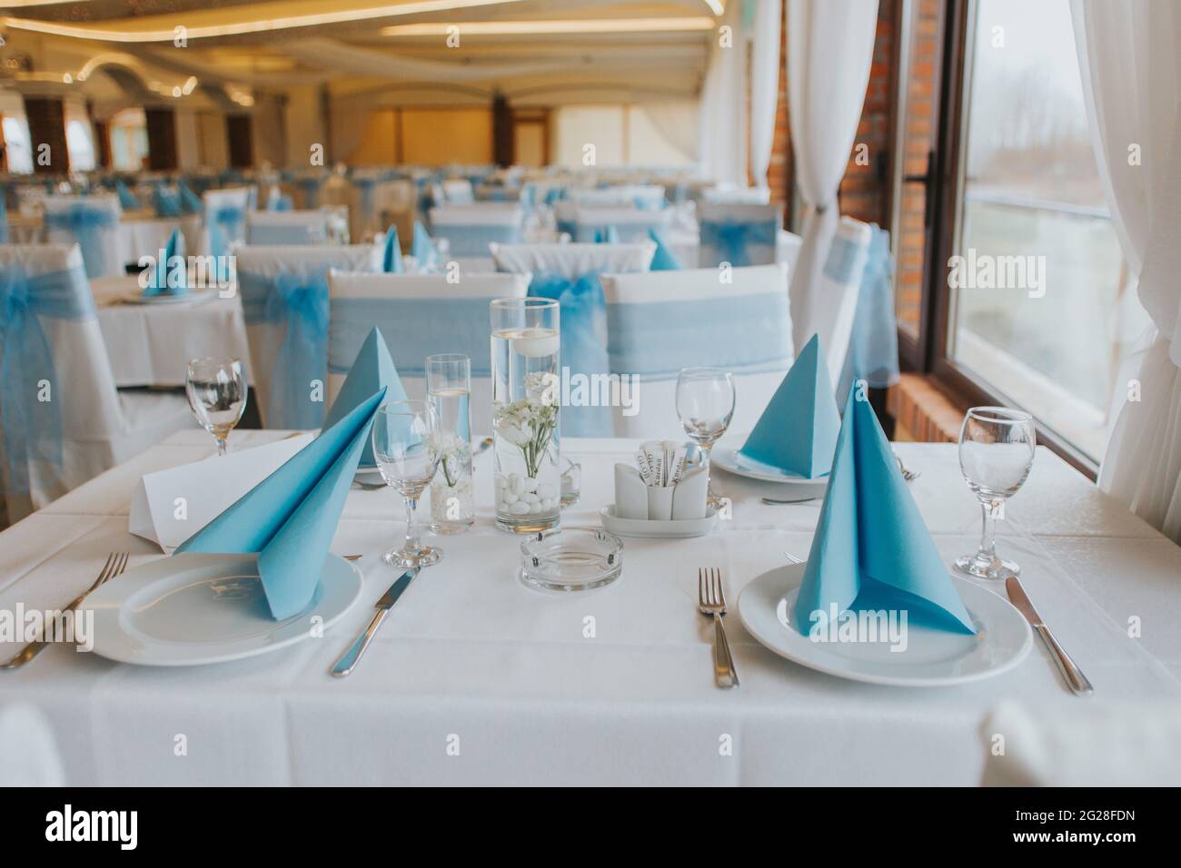 Banquet hall decorated for a wedding in white and blue Stock Photo - Alamy