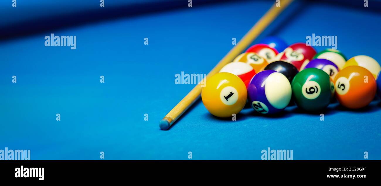 billiard pool balls rack and cue on the blue cloth table. banner copy ...