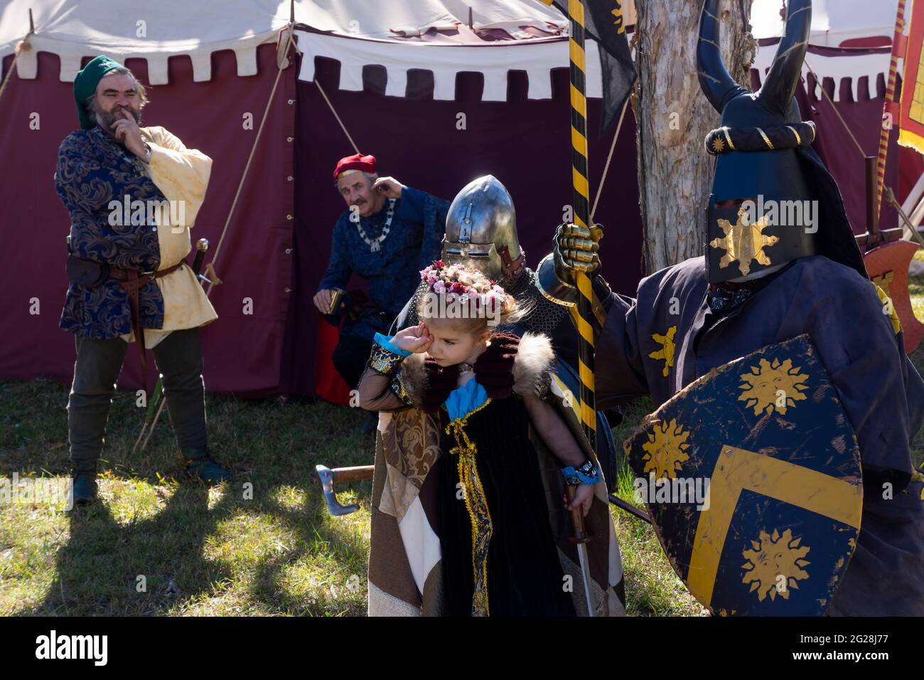 A group of people including a young child dressed in costume attending ...