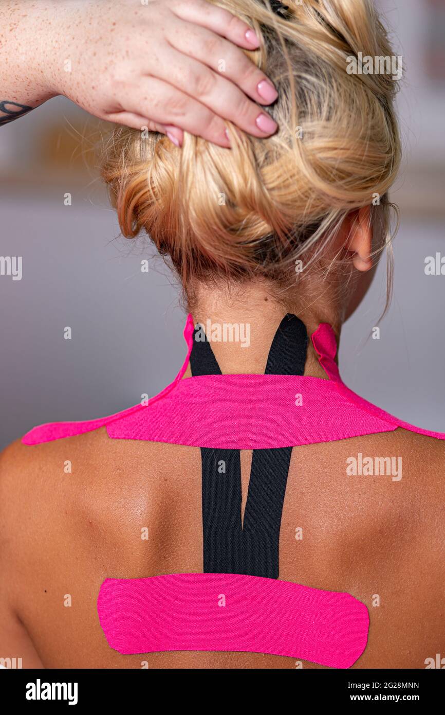 kinesio taping on the body, neck back in the salon Stock Photo - Alamy