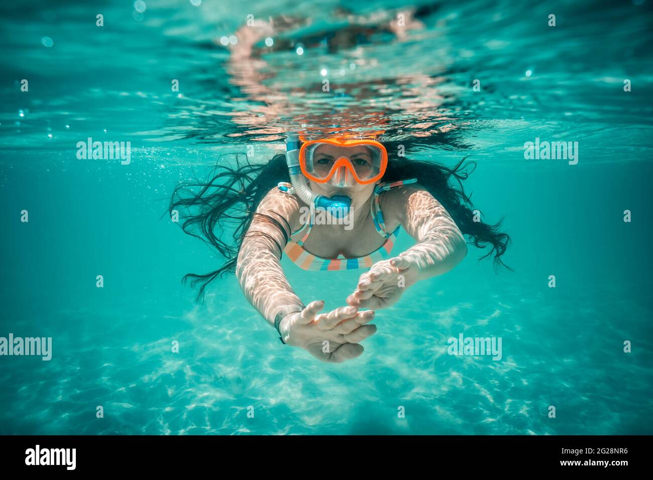 Underwater View Of Beautiful Woman Swimming In Blue Ocean Water Stock