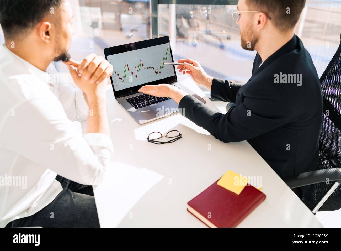 Office worker showing company income chart to his boss Stock Photo - Alamy