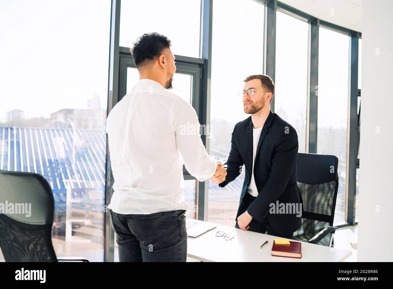 Businessmen shake hands in interview hi-res stock photography and ...