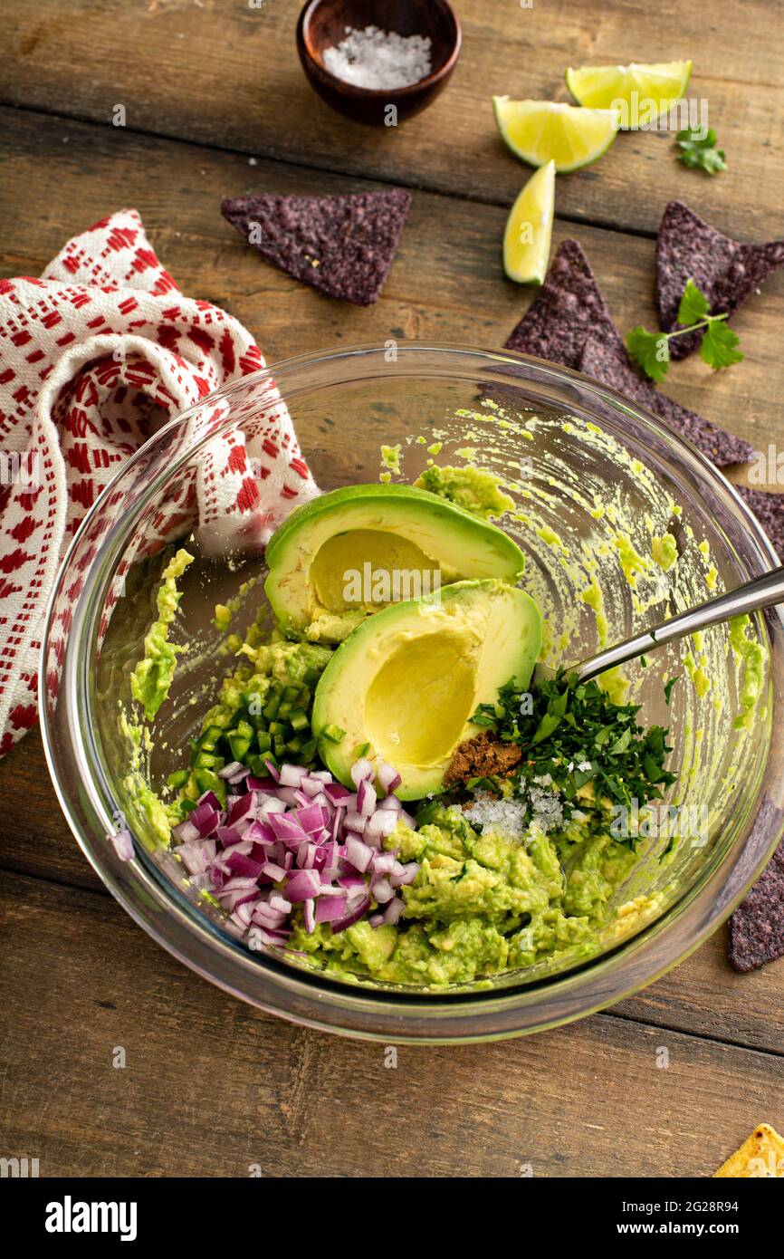 Making guacamole with red onion, jalapeno and cilantro Stock Photo - Alamy