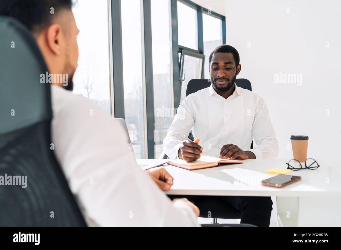 Company manager conducts interview for a man Stock Photo - Alamy