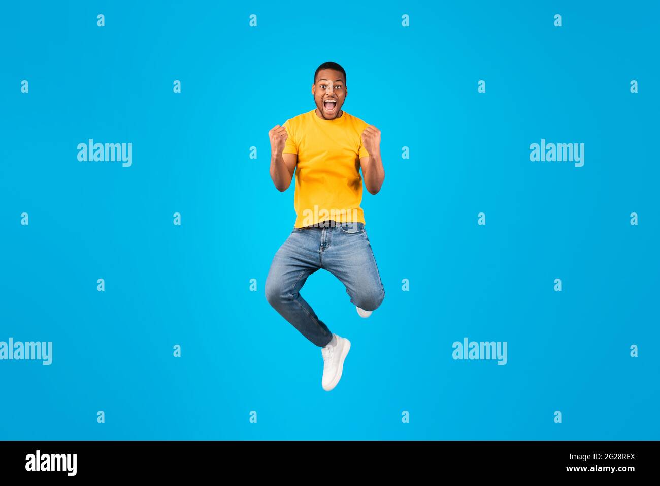 Emotional Black Guy Shouting Gesturing Yes In Mid-Air, Blue Background ...