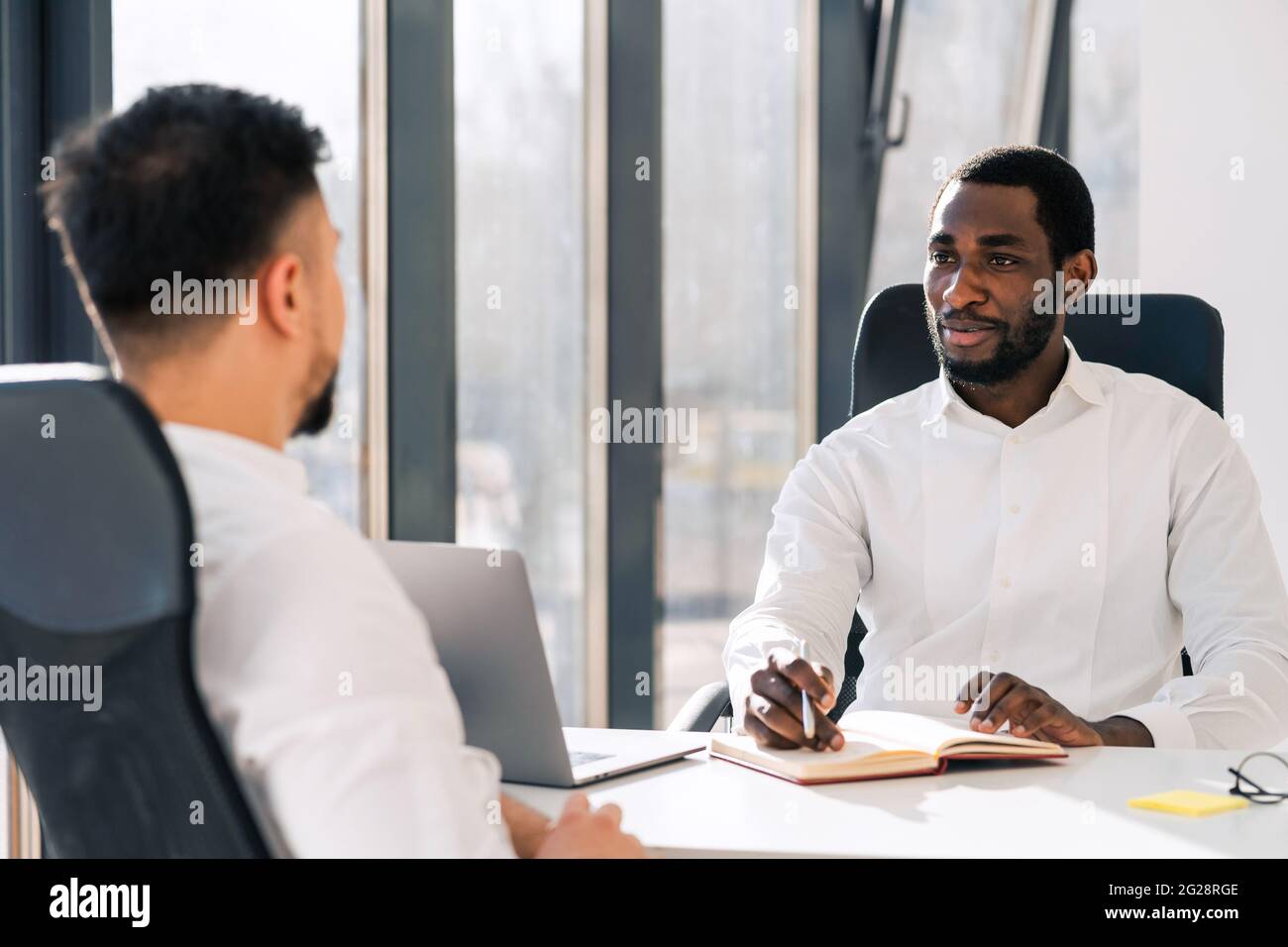 Black job interview serious hi-res stock photography and images - Alamy