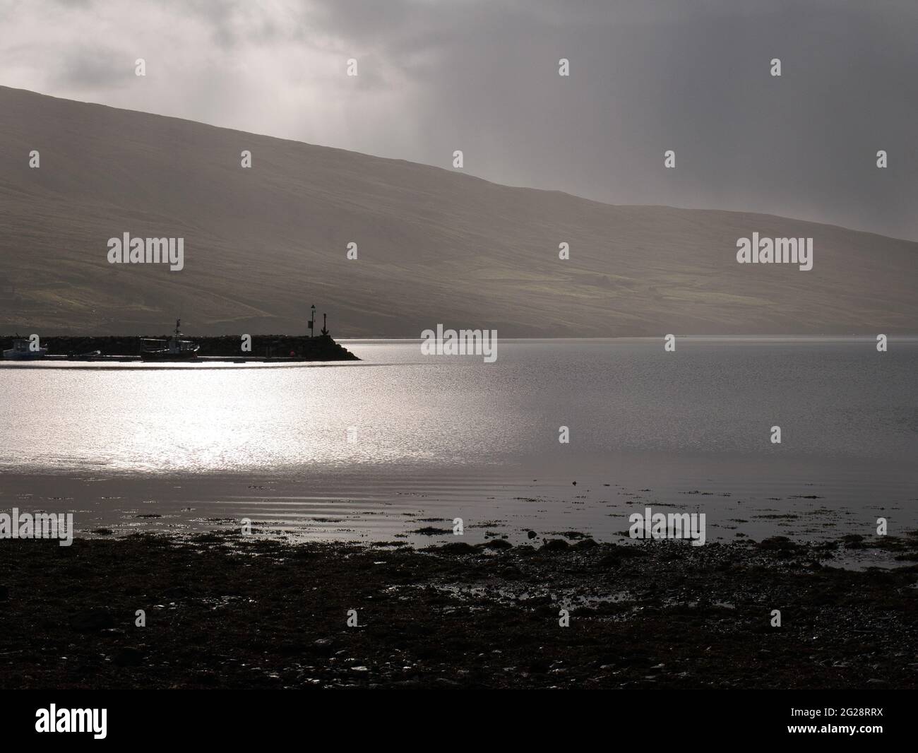 A grainy, moody almost black and white view of sunlight on the the ...