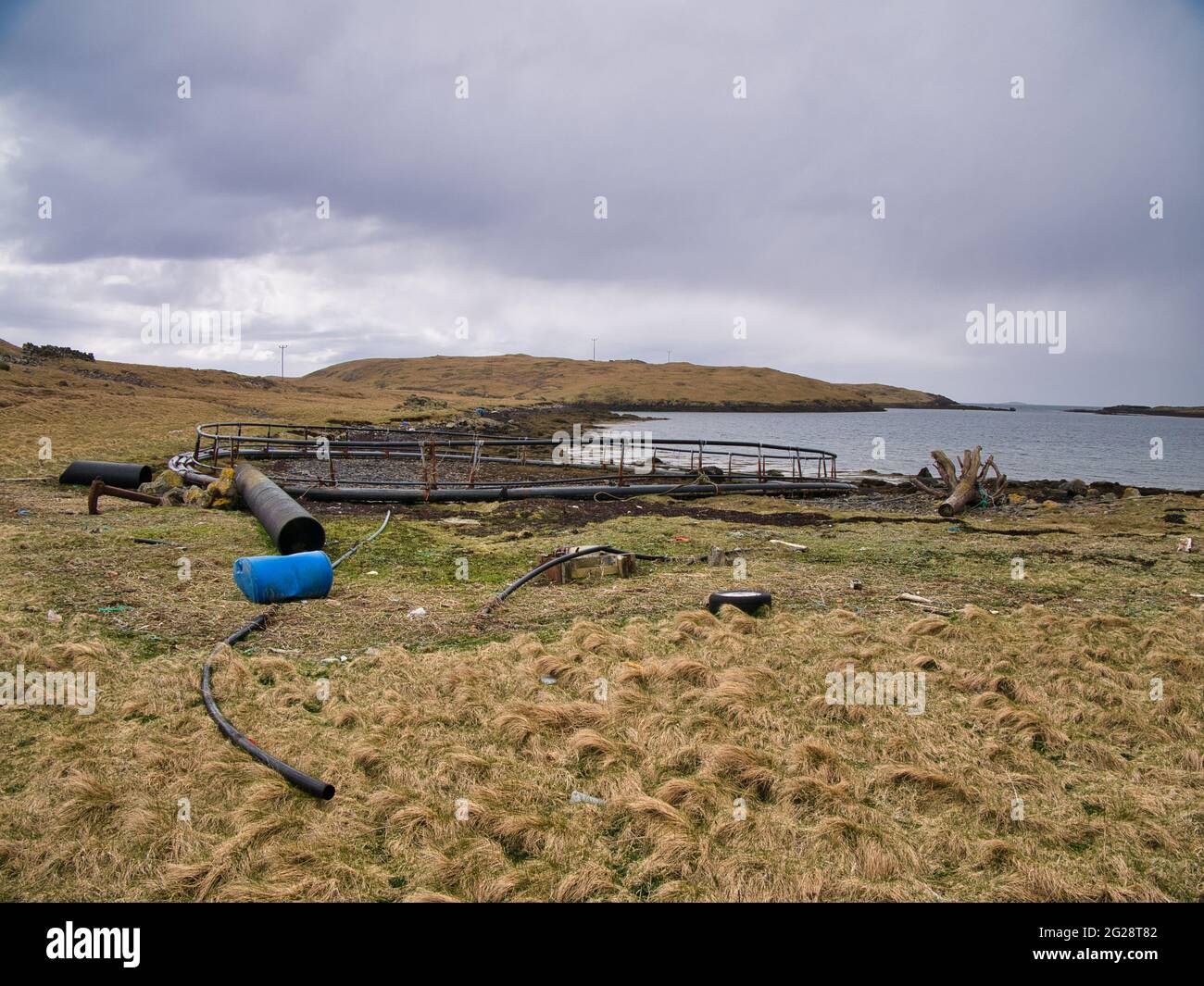 Abandoned plastic fish farming pens and other material connected to ...