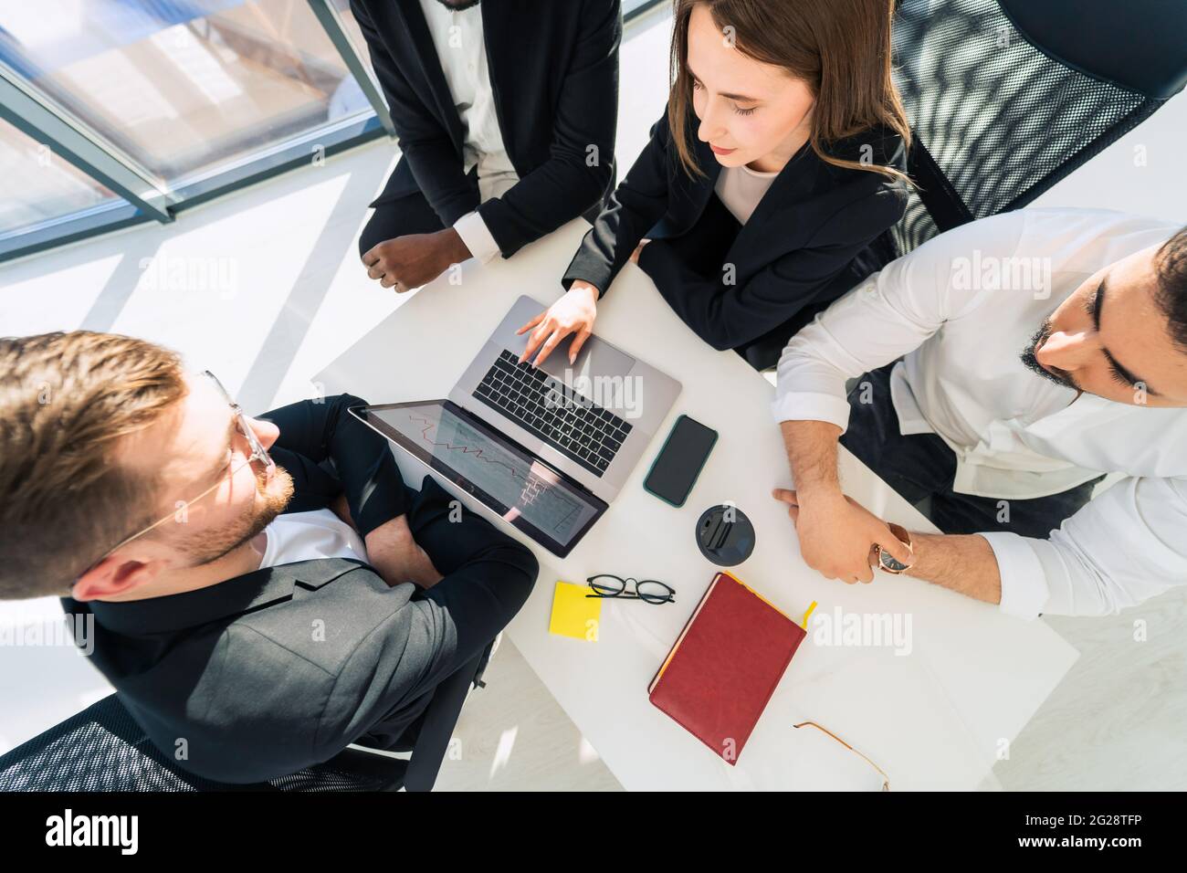 Top view office workers behind a laptop Stock Photo - Alamy