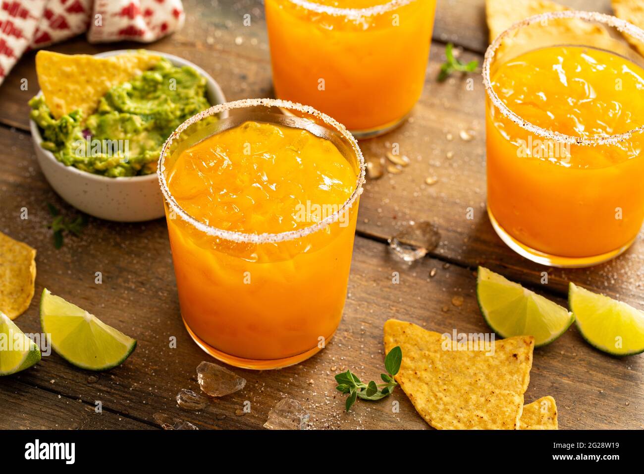 Pineapple and mango margarita with chips and guacamole Stock Photo - Alamy