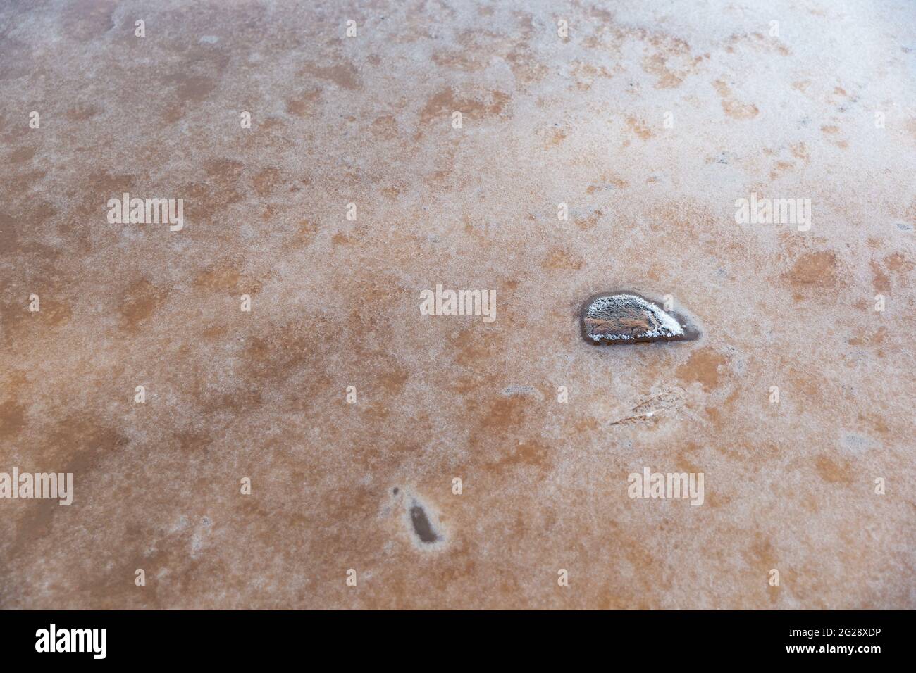 loneliness. the texture of a salty lake with admixtures of red copper ...