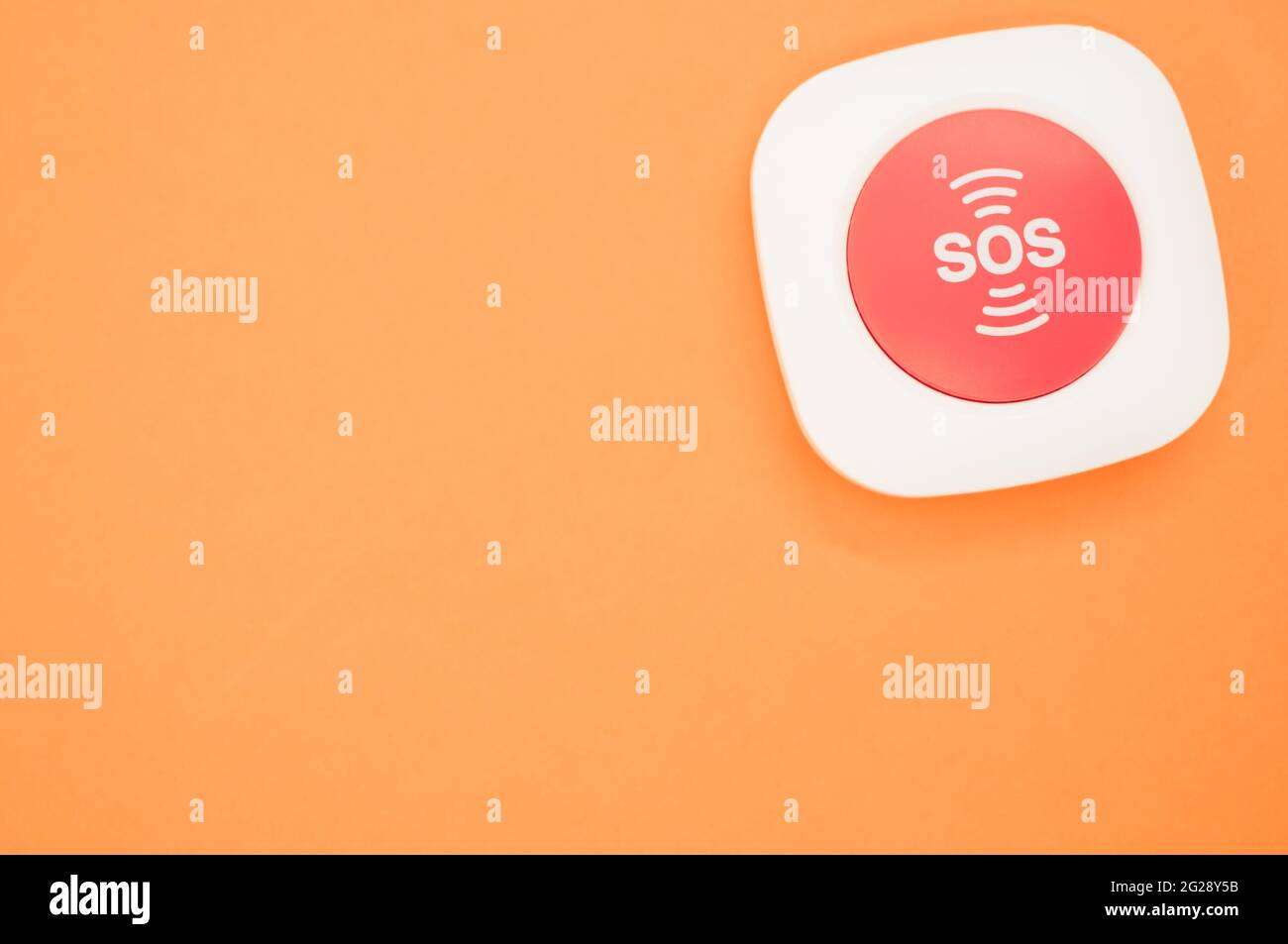 Top view of an SOS button on an orange surface Stock Photo - Alamy