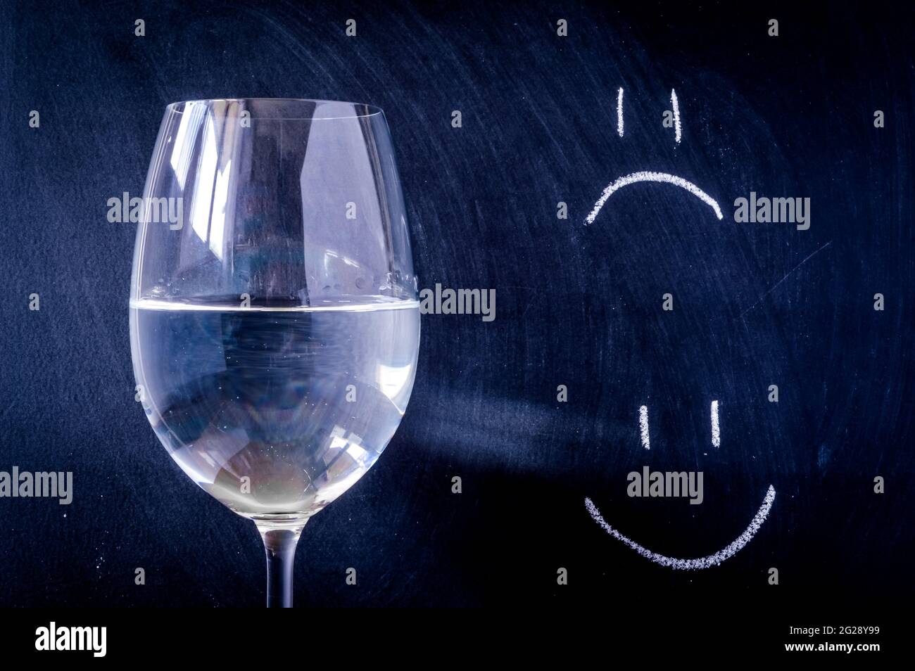 Half-full or half-empty glass of water, with an happy smiley and ...