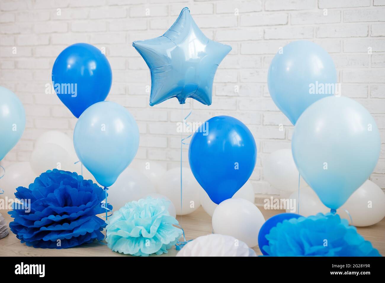 birthday party decoration - blue air balloons and paper balls over ...