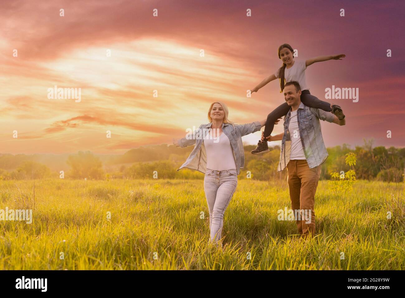 Happy family: mother father and child daughter on nature on sunset ...