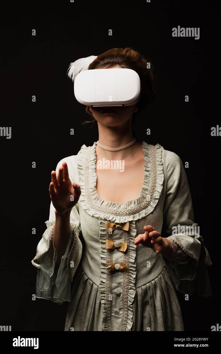 vintage style woman in pastel grey dress gaming in vr headset isolated ...