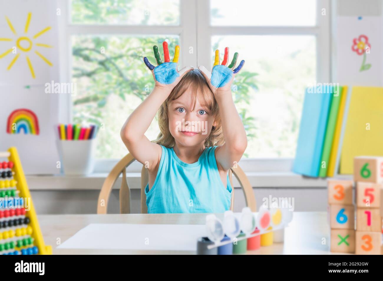 Funny beautiful happy child boy shows hands dirty with paint. Kid draws ...