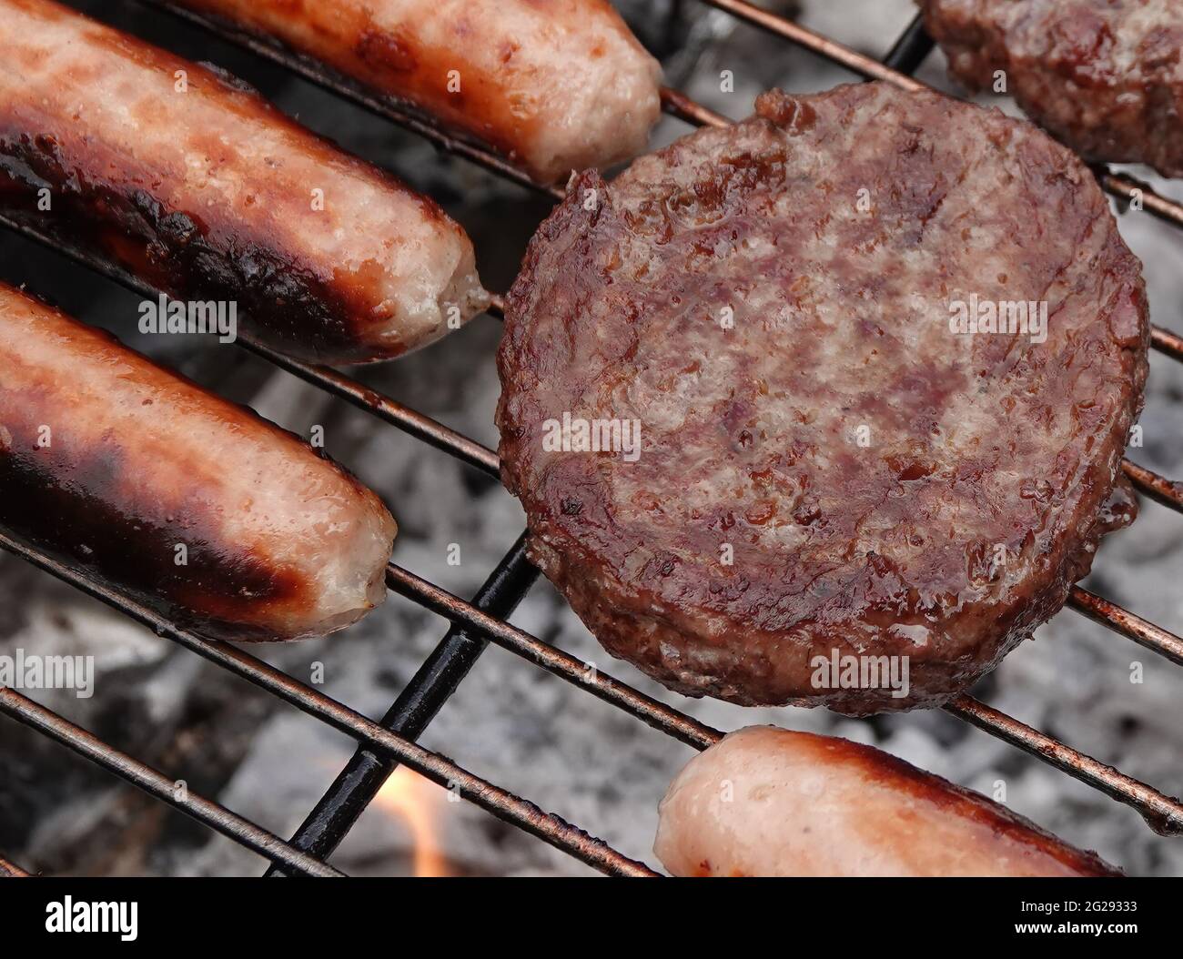 Overhead shot of burger parries and sausage on the grill Stock Photo ...