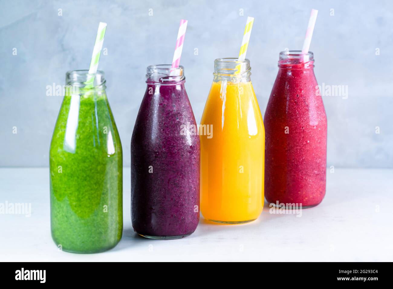 Colorful smoothie in glass bottles. Summer fruit smoothies in jars ...