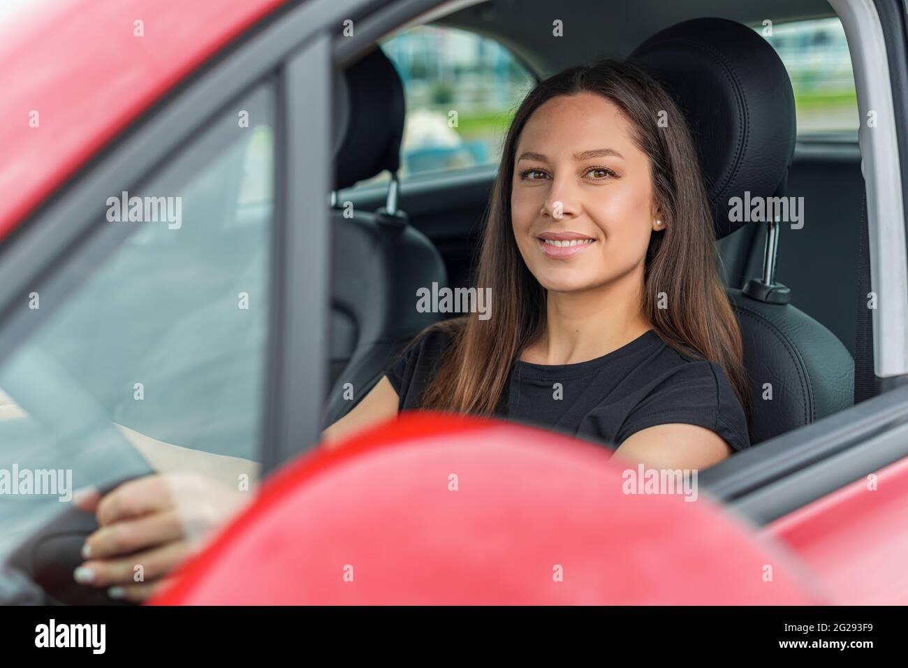Beautiful young woman driving a car Stock Photo - Alamy