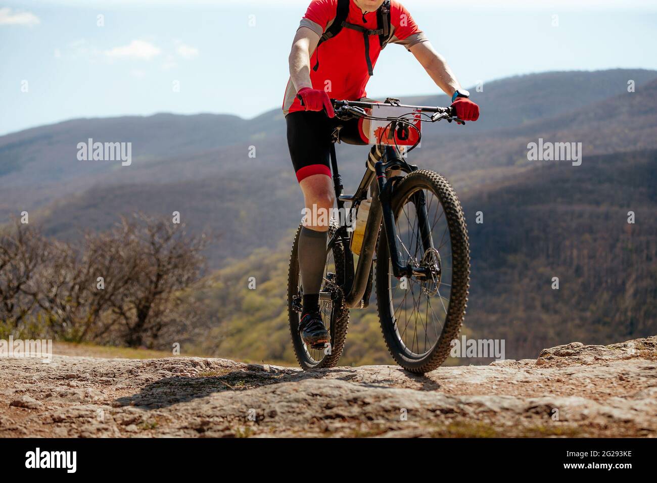 male athlete on mountain bike biking in background of mountain Stock ...