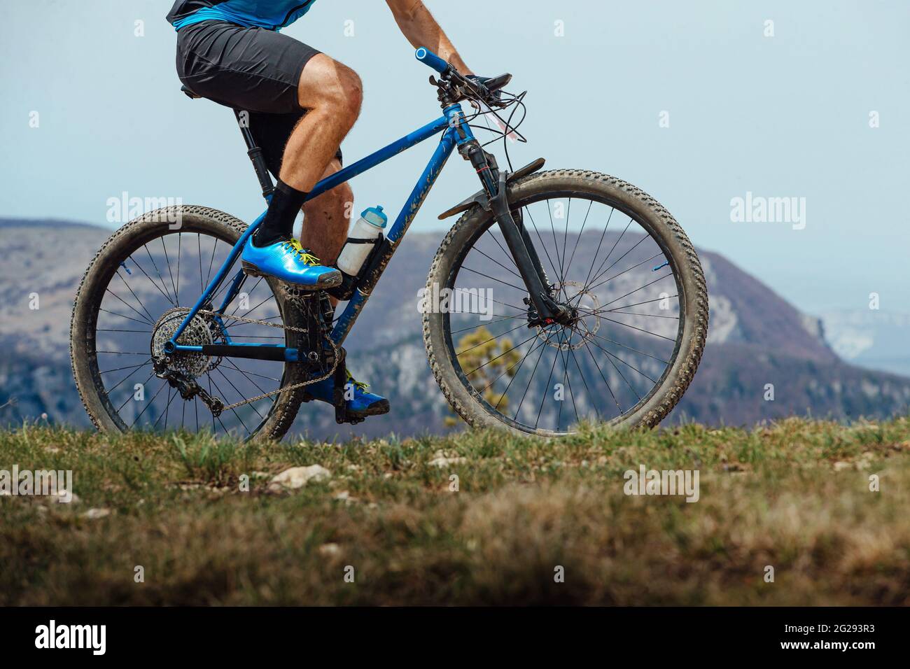 closeup man on mountain bike riding trail in background of mountain ...