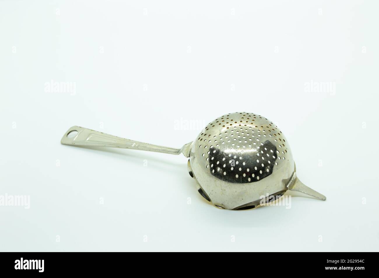 A shiny old tea sifter with upside down isolated on white Stock Photo ...