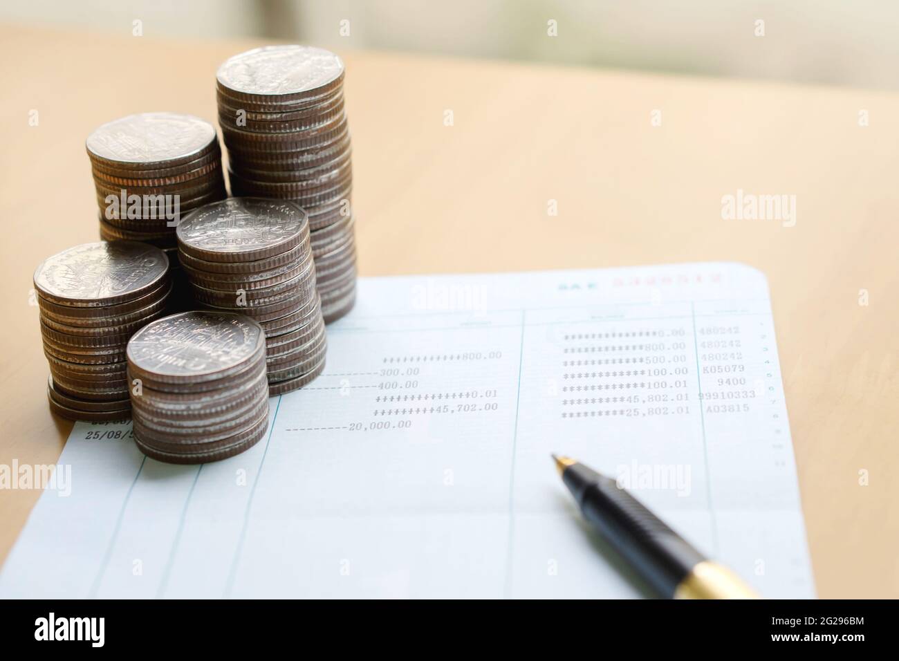 Coins stack in columns with saving book finance and banking concept for ...