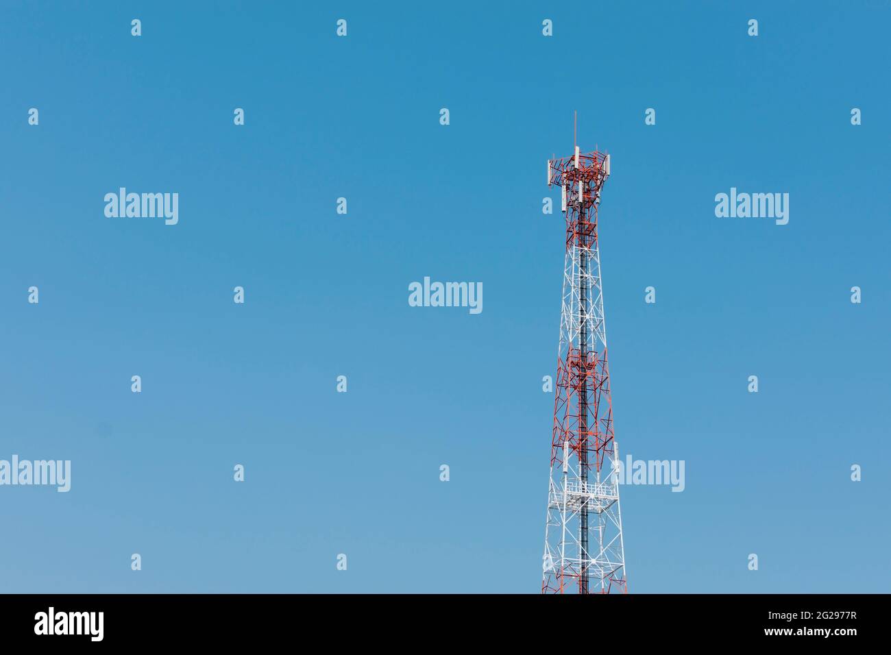 Antenna repeater tower on blue sky background Stock Photo - Alamy
