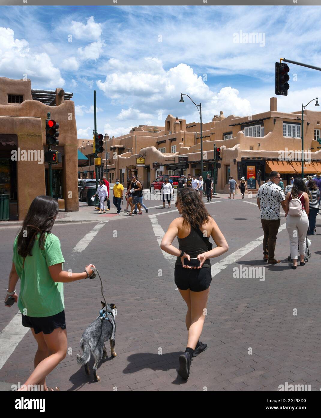 Visitors cross a busy intersection in the historic Plaza dstrict in ...