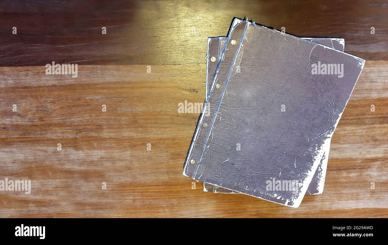 Old book on wooden desk Stock Photo - Alamy