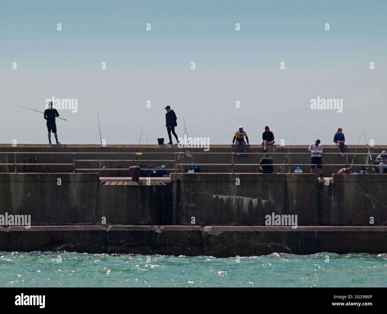 Fishing from the seawall at Shoreham by Sea, Sussex Stock Photo - Alamy