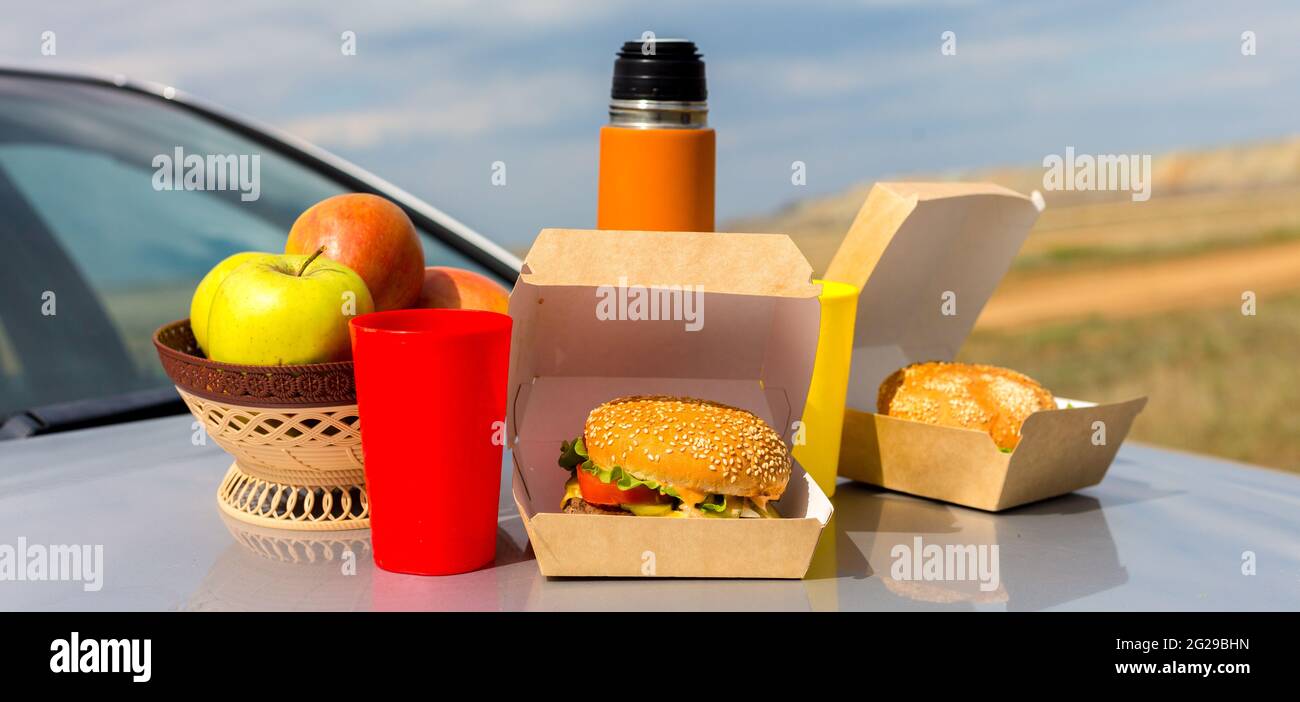 Lunch in nature on the hood of the car after a long trip Stock Photo ...
