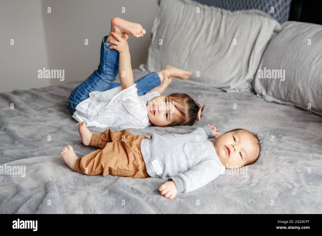 Asian Chinese girl and little newborn baby brother playing together ...