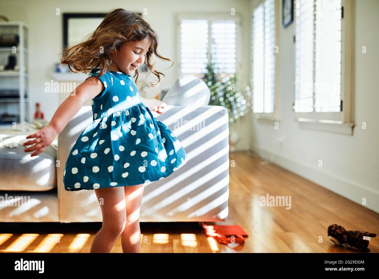 Cute girl dancing in living room at home Stock Photo - Alamy