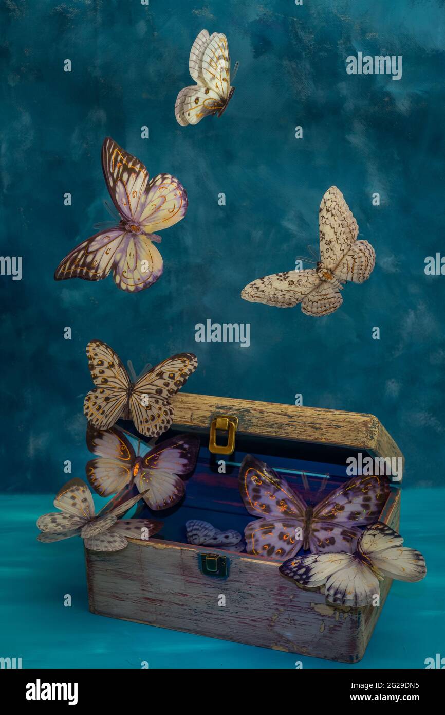 artificial butterflies flying on a blue background Stock Photo - Alamy