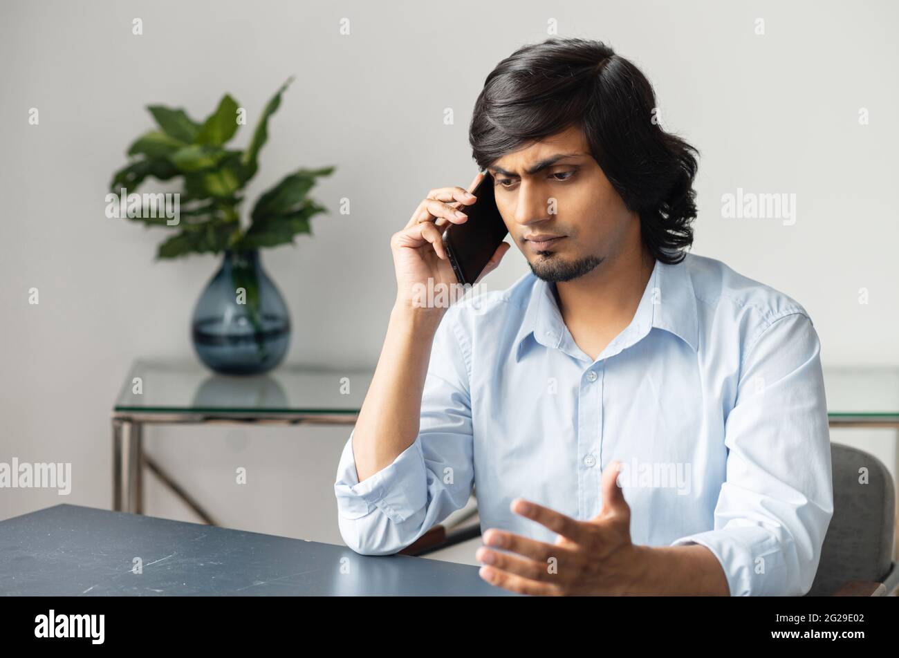 Upset indian businessman is talking on the smartphone, portrait of sad ...