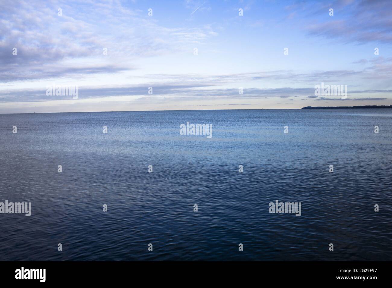 Calm sea under the sunset sky Stock Photo - Alamy