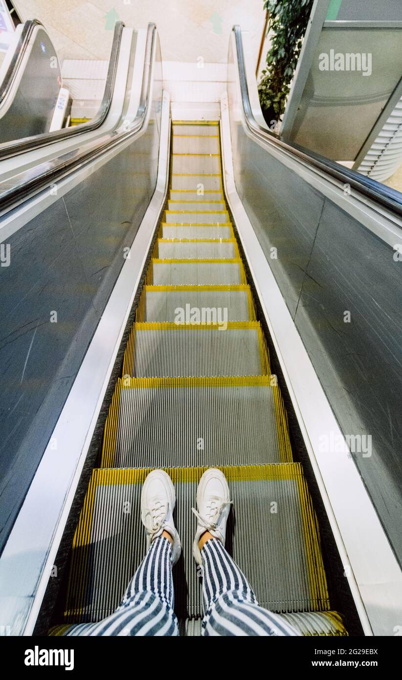 Shoes on escalator hi-res stock photography and images - Alamy