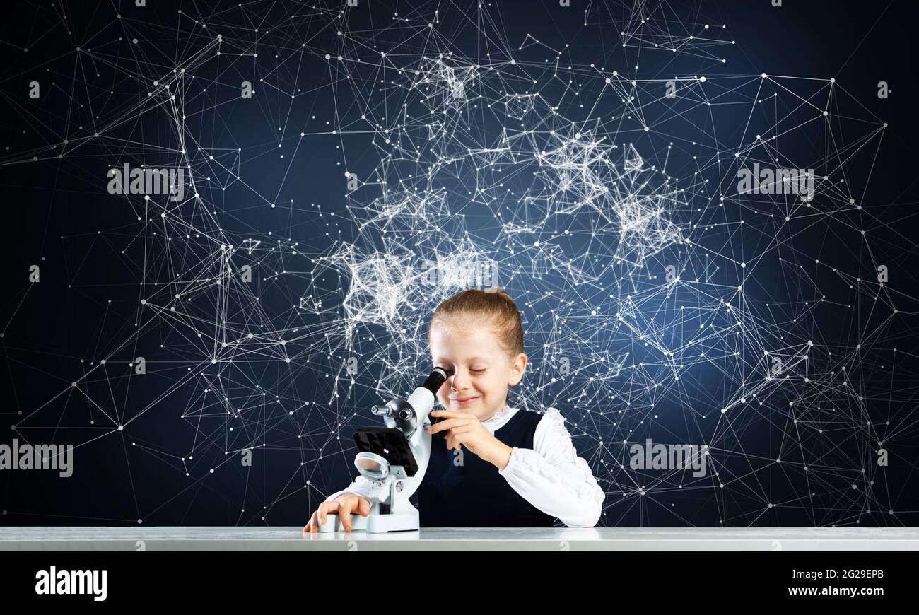 Little scientist looking through microscope Stock Photo - Alamy