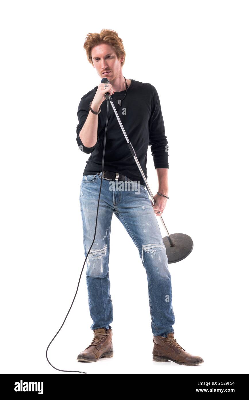 Tough macho rock music male singer carrying microphone looking at ...
