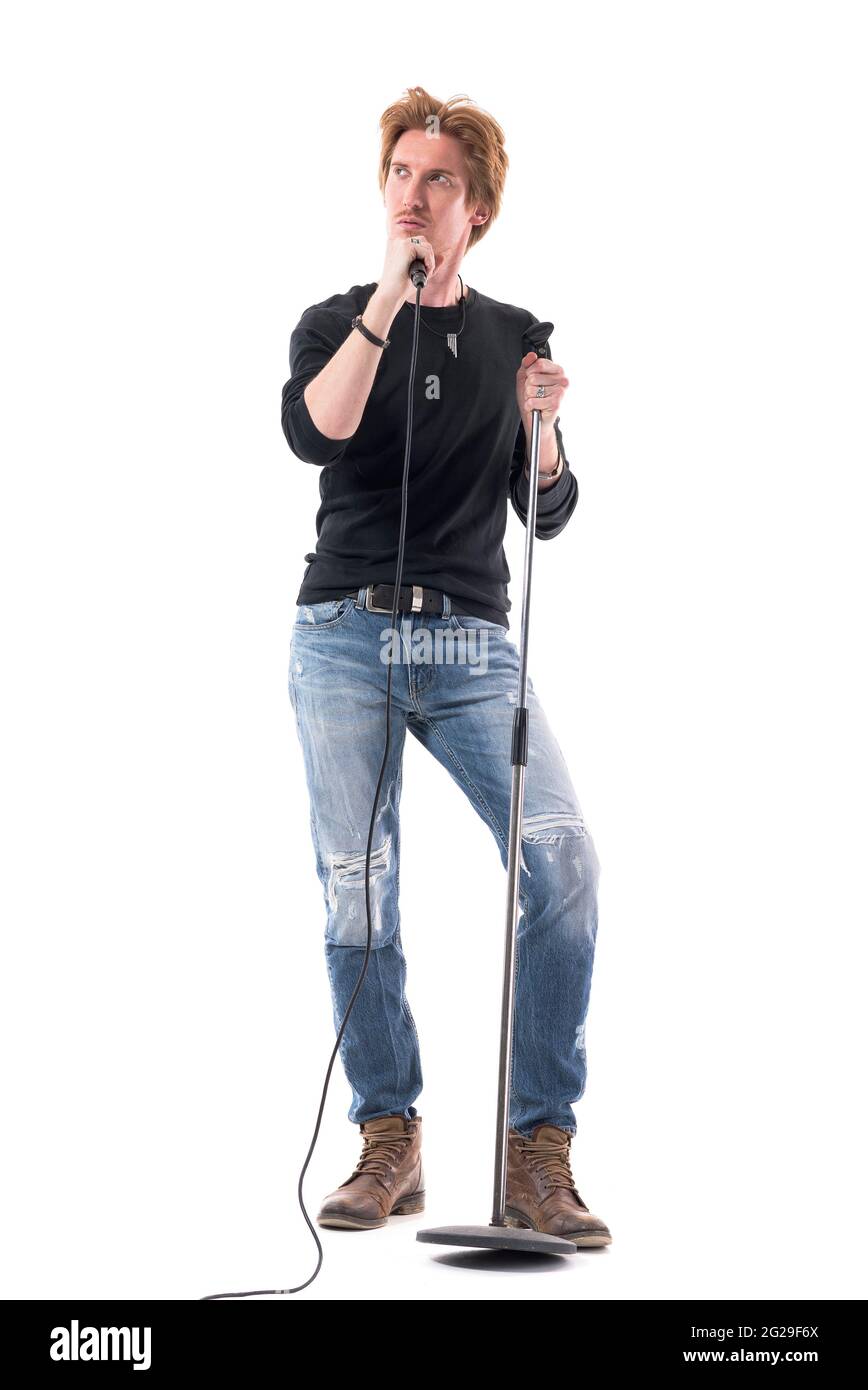 Cool stylish handsome male rocker posing with microphone looking away ...