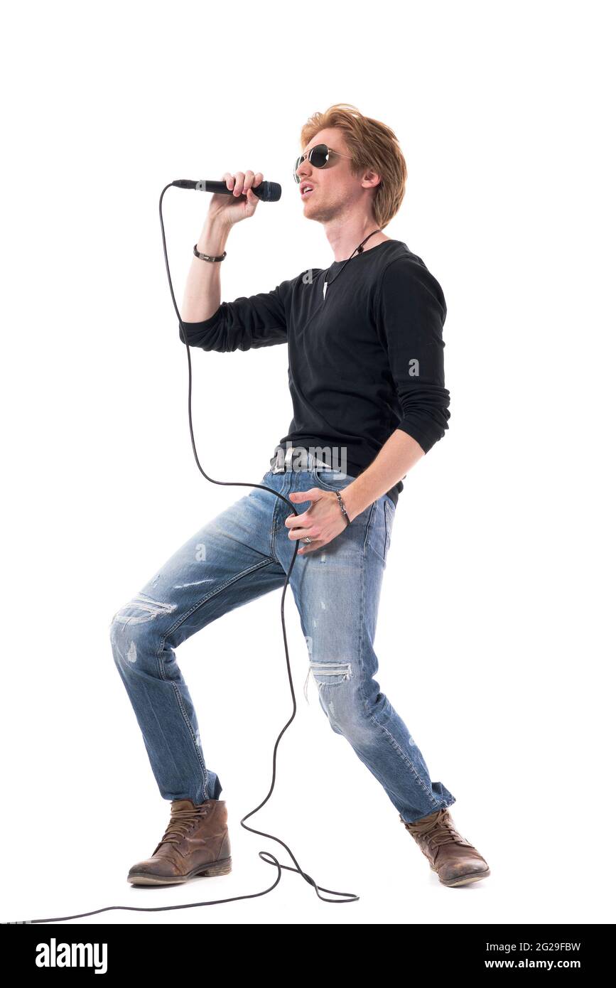 Side view of energetic passionate rocker singer singing loud on ...